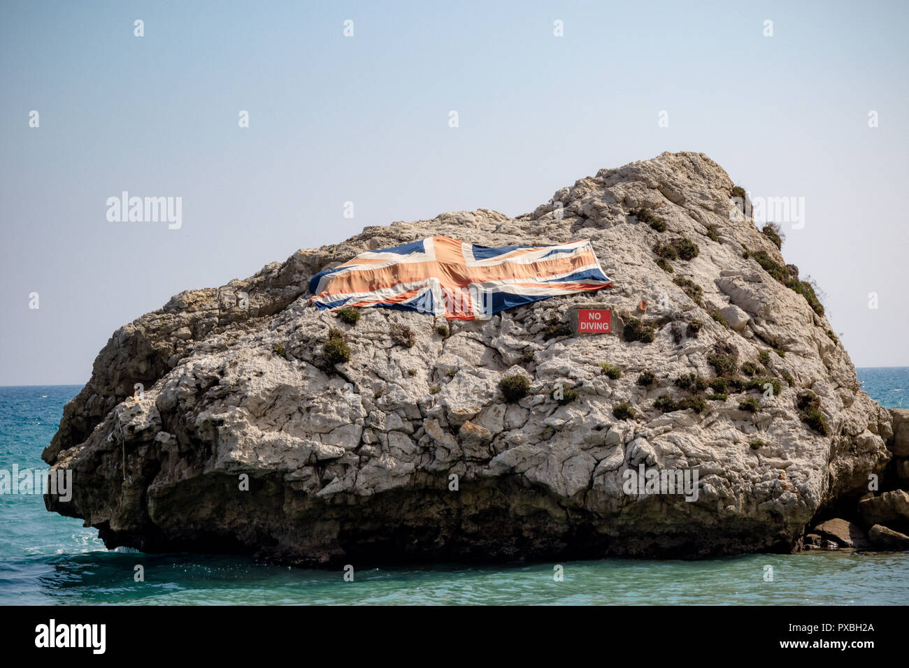 A large rock with the Union Jack in Catalan Bay on the East side of the ...