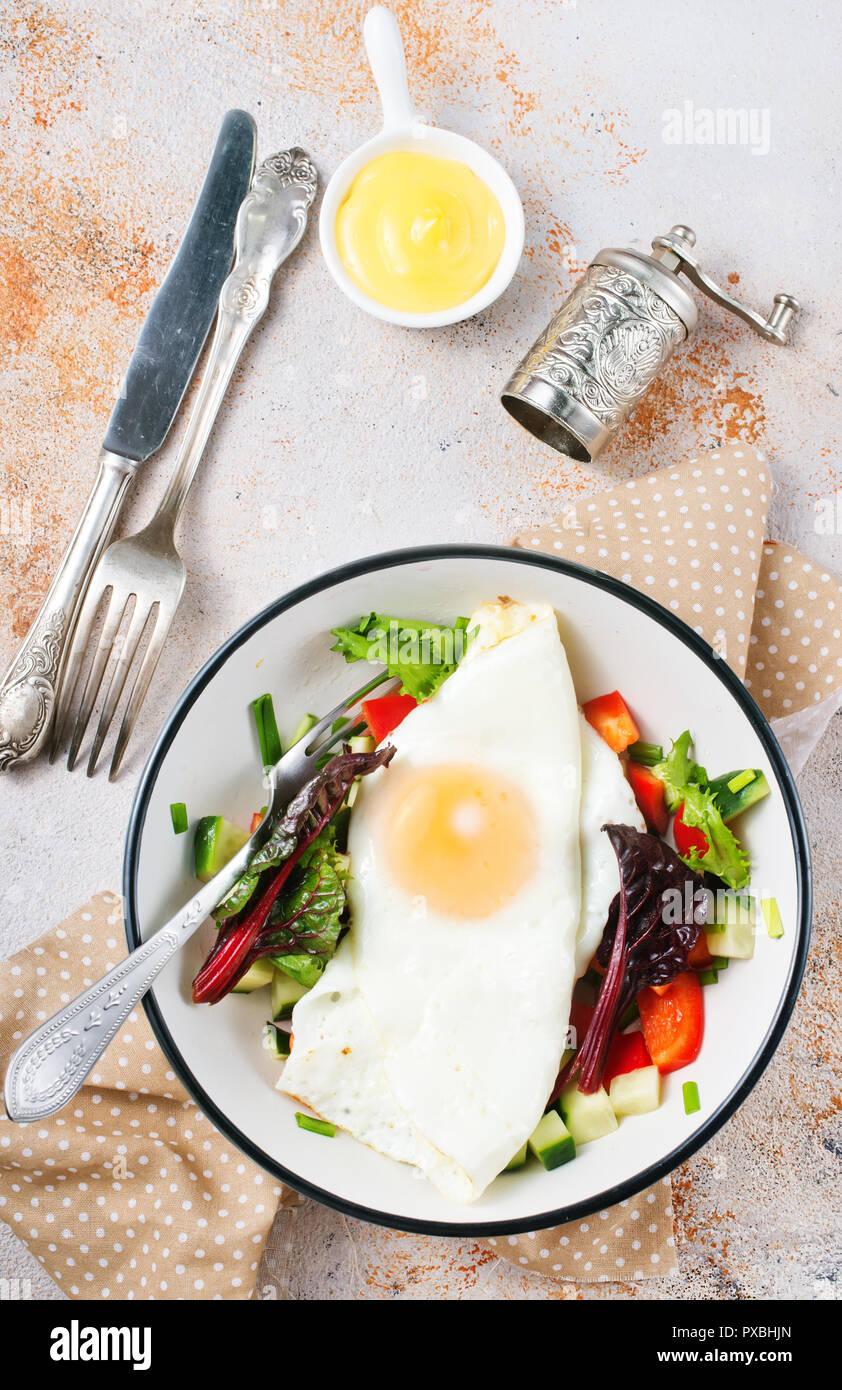 breakfast on plate, fried egg with salad Stock Photo - Alamy