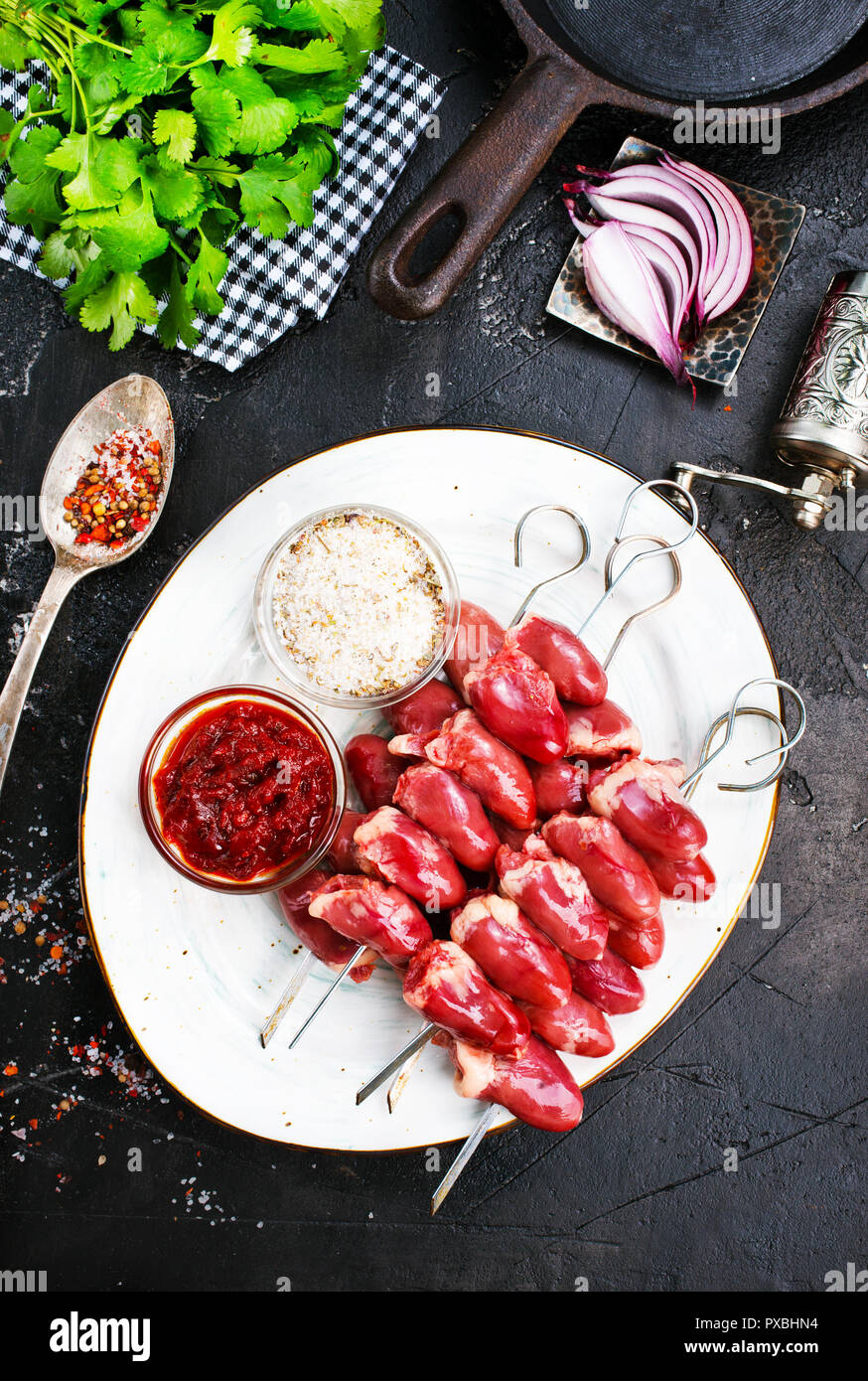 raw chicken hearts with salt and spice Stock Photo - Alamy