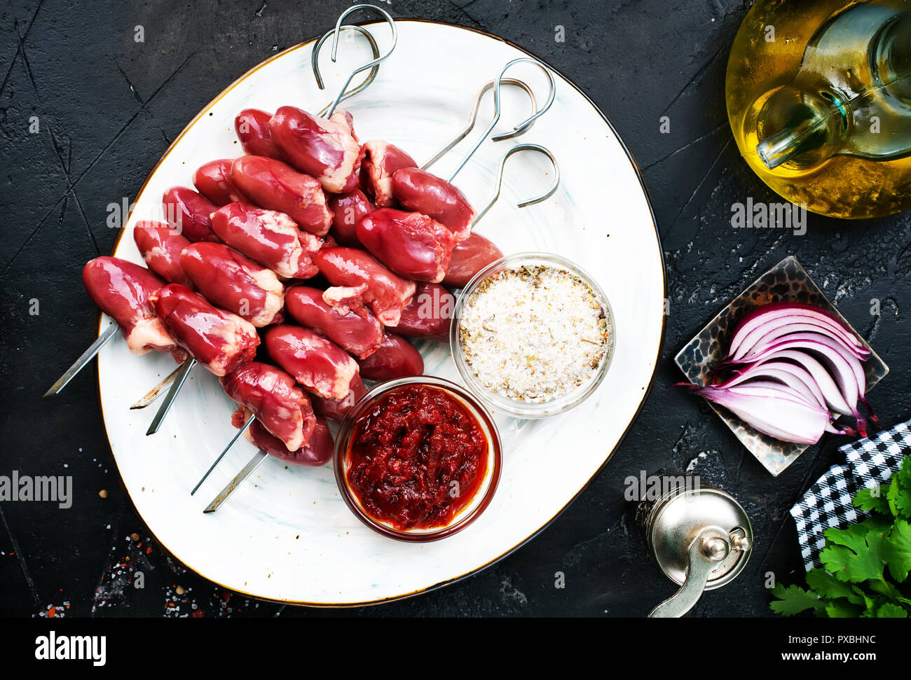 raw chicken hearts with salt and spice Stock Photo - Alamy