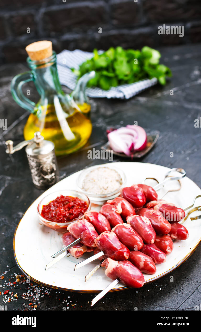 raw chicken hearts with salt and spice Stock Photo - Alamy