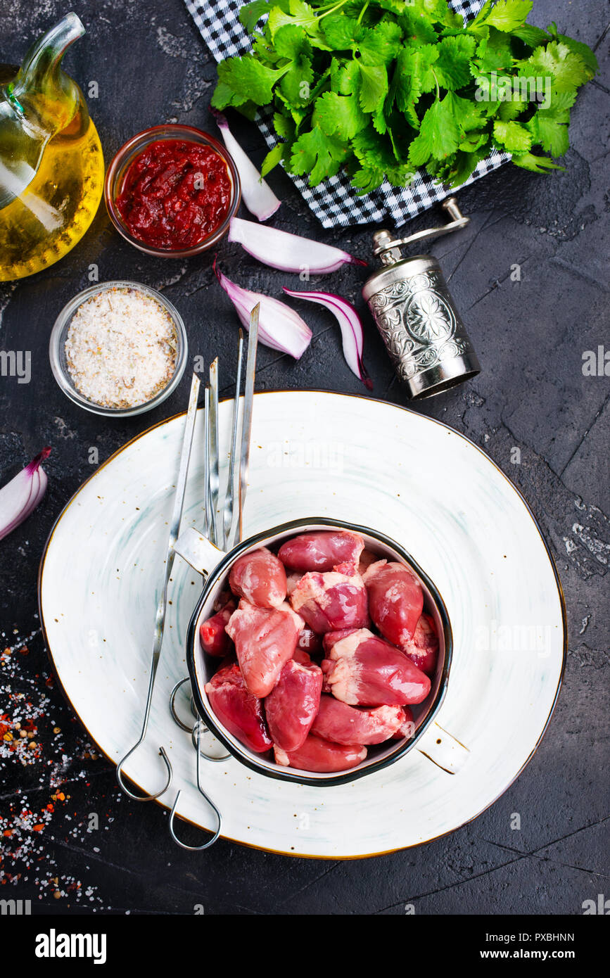 raw chicken hearts with salt and spice Stock Photo - Alamy