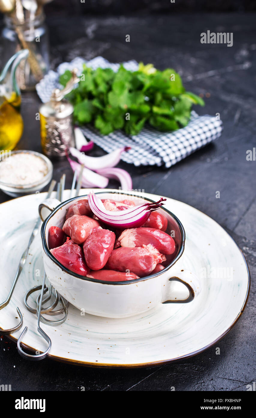 raw chicken hearts with salt and spice Stock Photo - Alamy