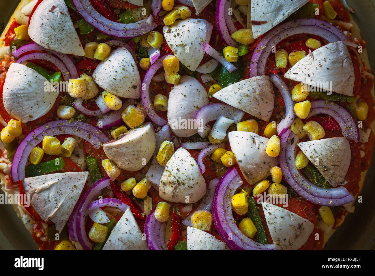Fresh Pizza ready for the Oven Stock Photo - Alamy