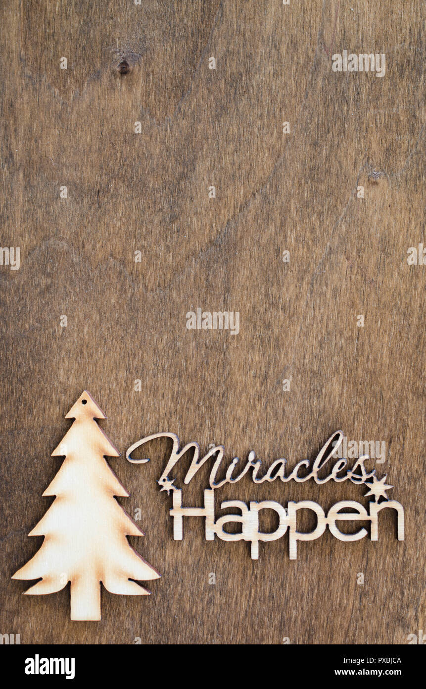Inscription miracles happen on a wooden background. Concept of ...