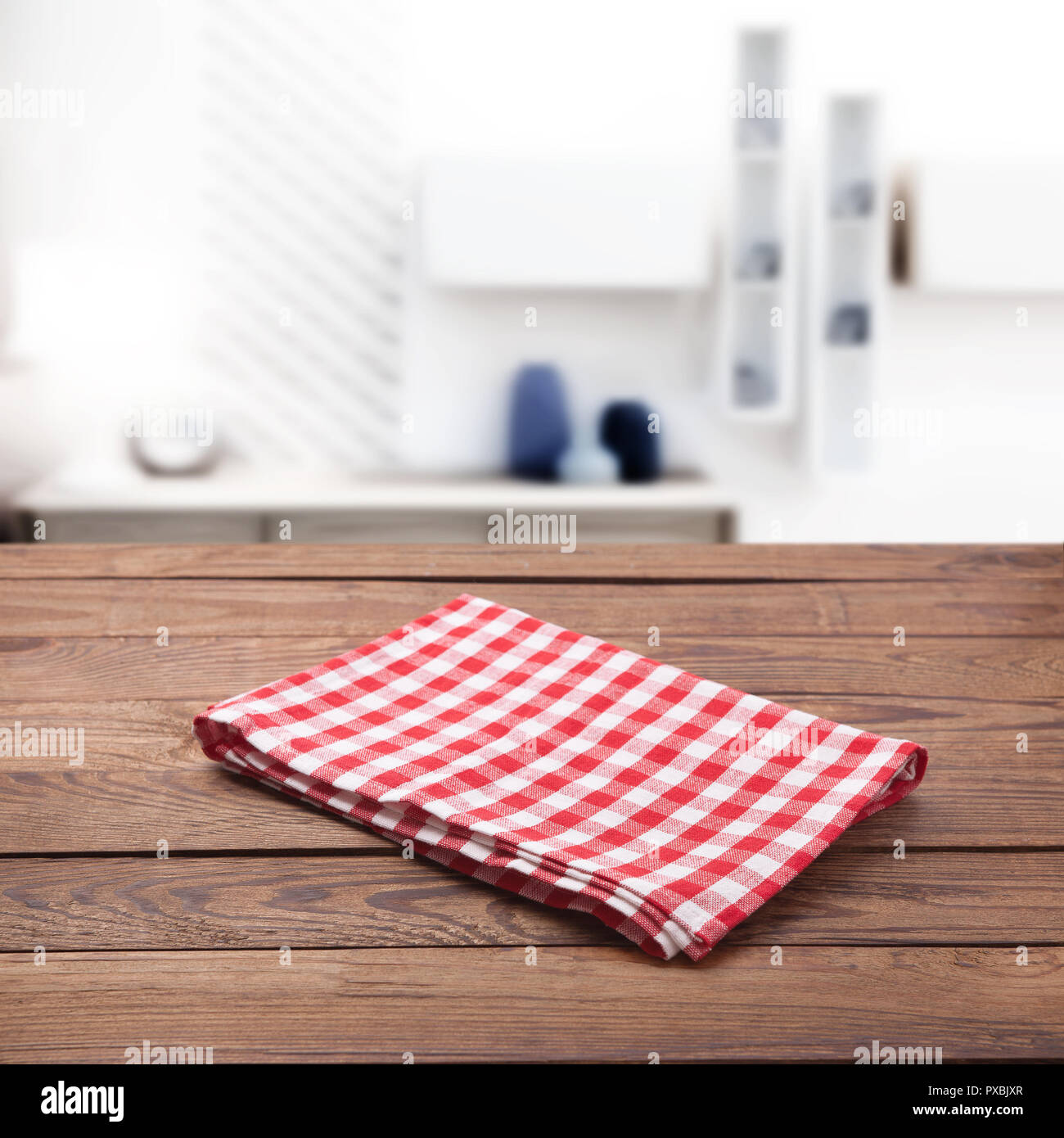 Kitchen towel on empty wooden table on kitchen interior background ...