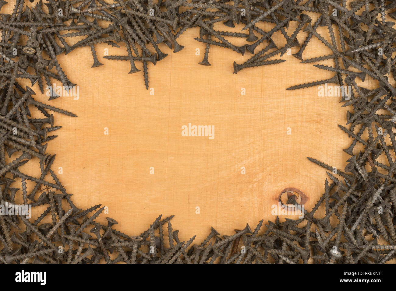 Frame made of screws on a wooden background, with space. Top view Stock ...