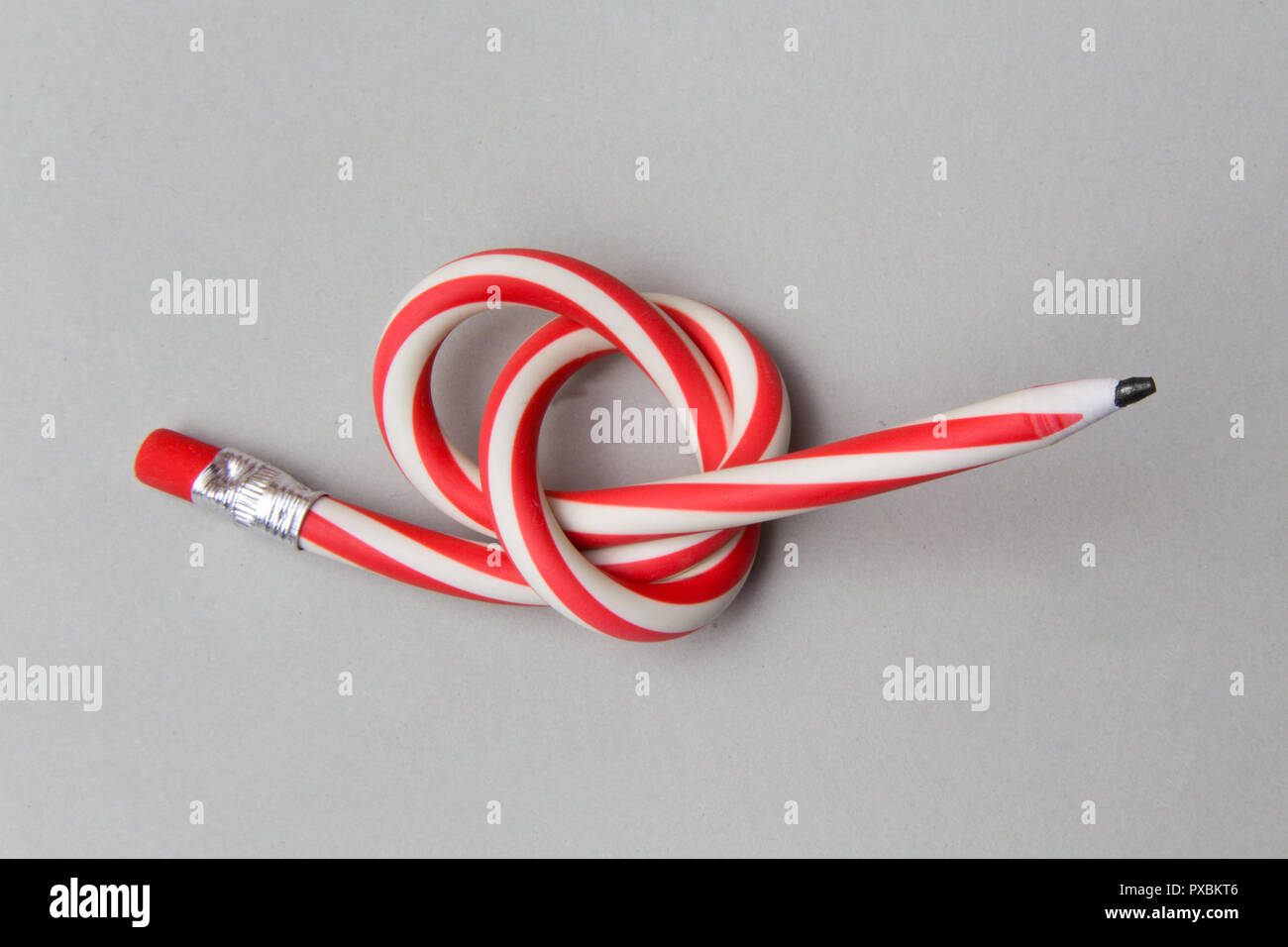 Flexible pencil on a grey background. Bent pencils two-color Stock ...