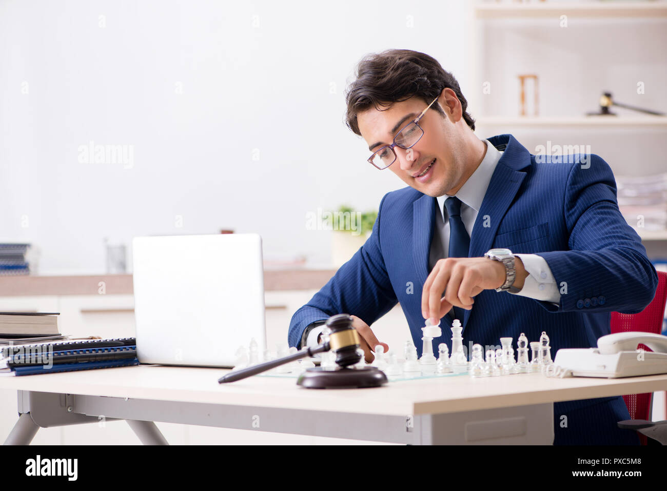 Young lawyer playing chess to train his court strategy and tactics ...