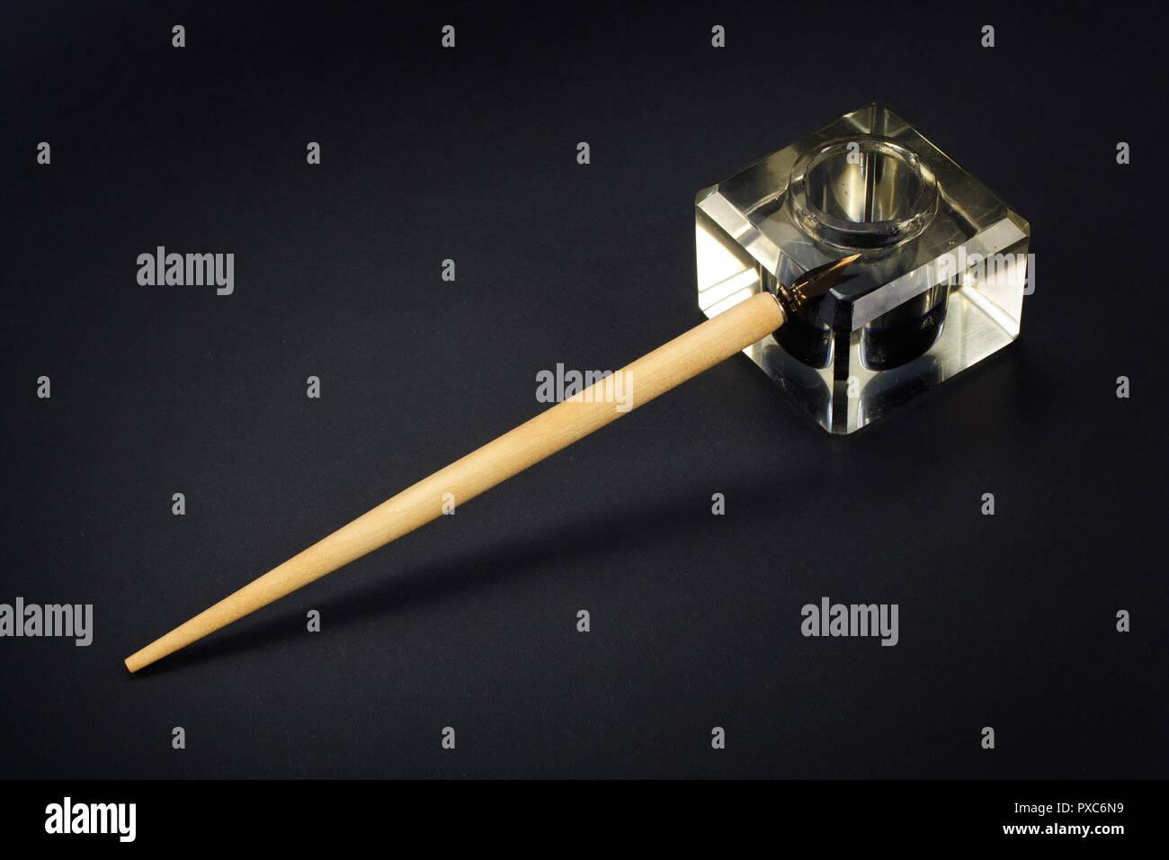 Old fountain pen and inkwell on a black background Stock Photo - Alamy
