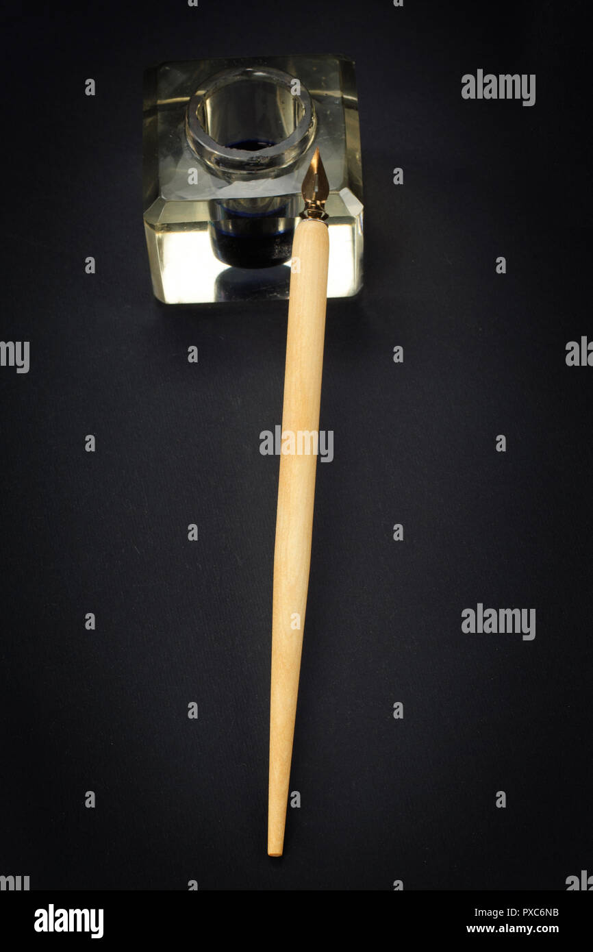 Old fountain pen and inkwell on a black background Stock Photo - Alamy