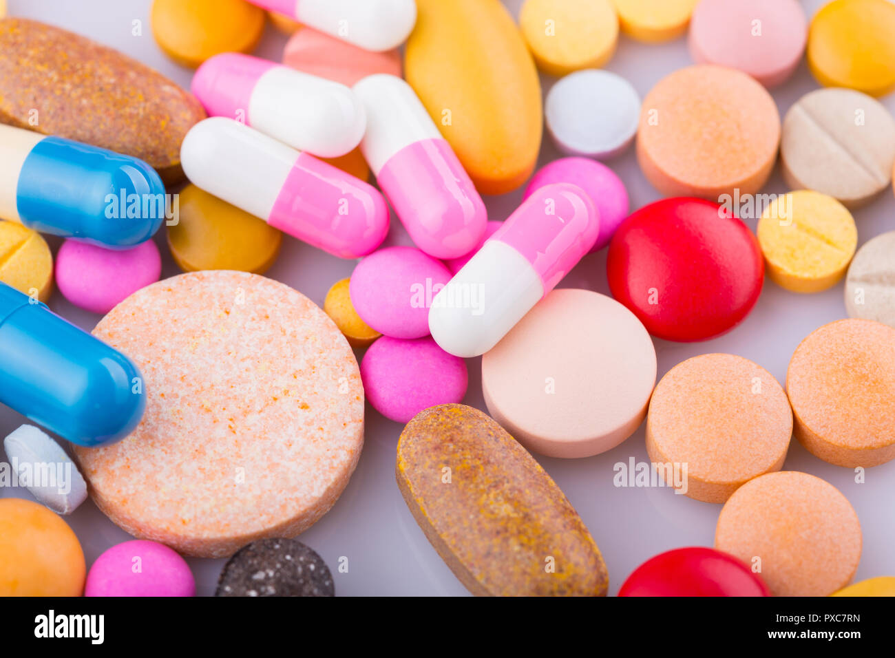 Tablets pills capsule heap mix therapy drugs, over a white background ...