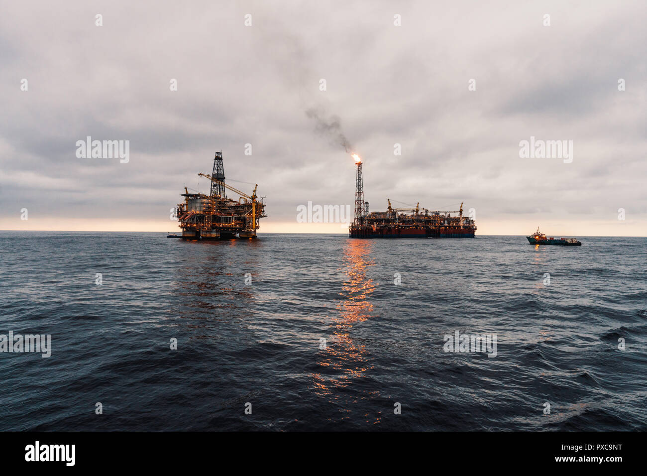 FPSO tanker vessel near Oil Rig platform. Offshore oil and gas industry ...