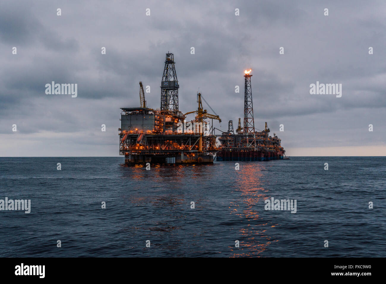 FPSO tanker vessel near Oil Rig platform. Offshore oil and gas industry ...