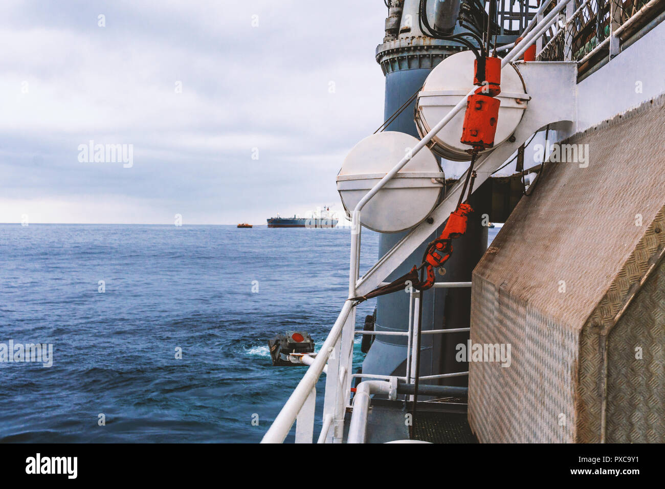 View of ocean from ship or vessel. LSA life saving equipment is on deck ...