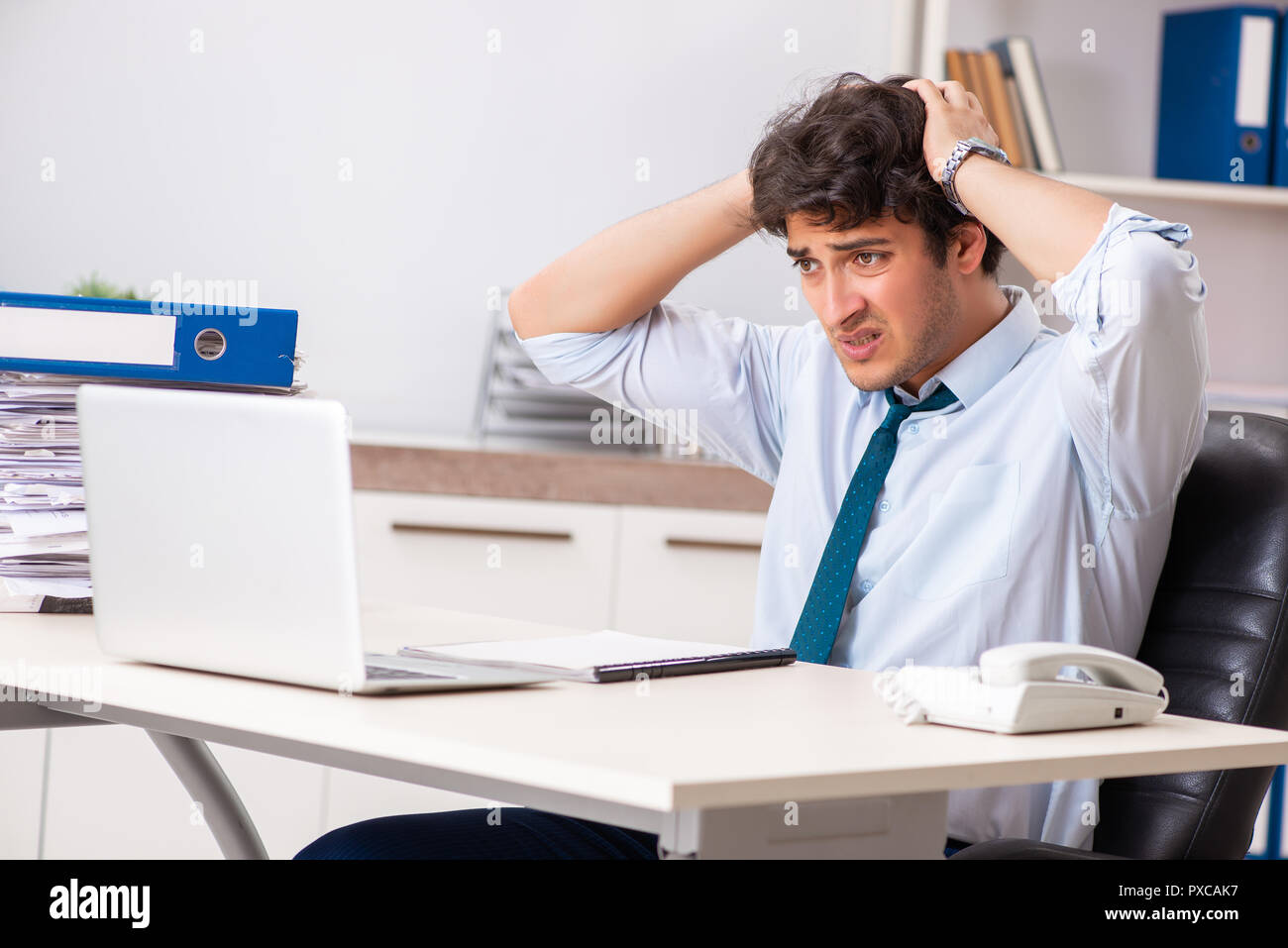 Overloaded busy employee with too much work and paperwork Stock Photo ...