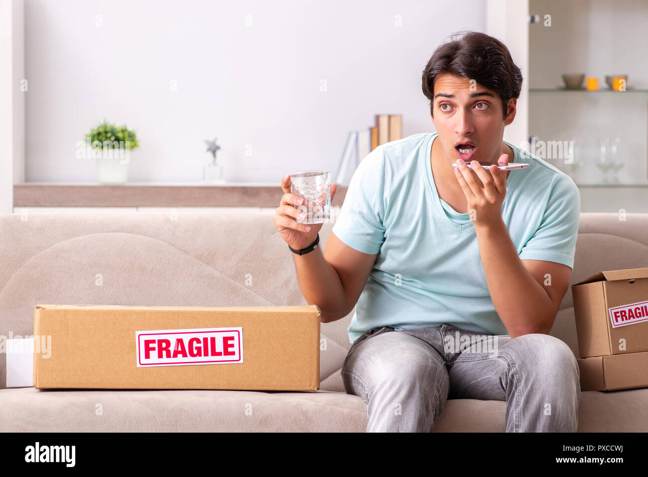 Man opening fragile parcel ordered from internet Stock Photo - Alamy