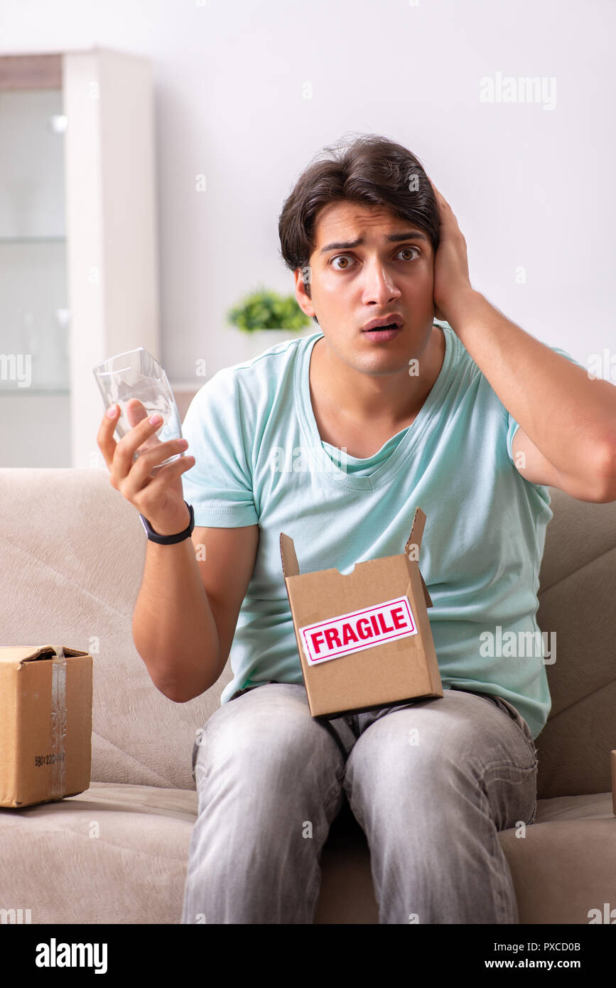 Man opening fragile parcel ordered from internet Stock Photo - Alamy