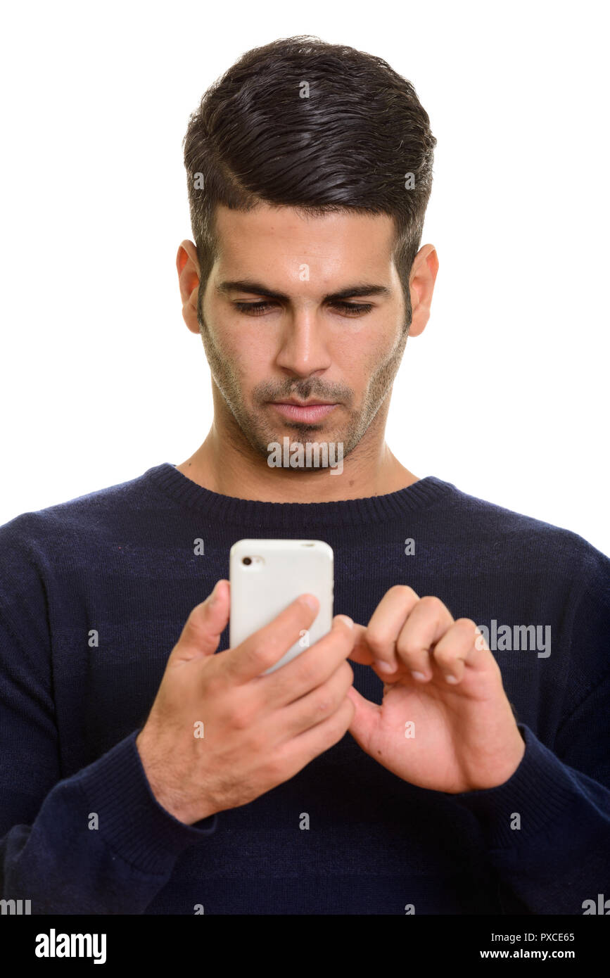 Face of young handsome Persian man using mobile phone touching t Stock ...
