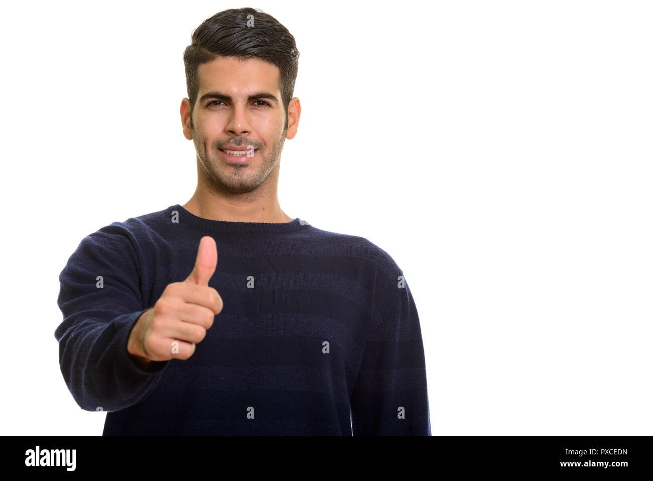 Young happy Persian man smiling and giving thumb up Stock Photo - Alamy