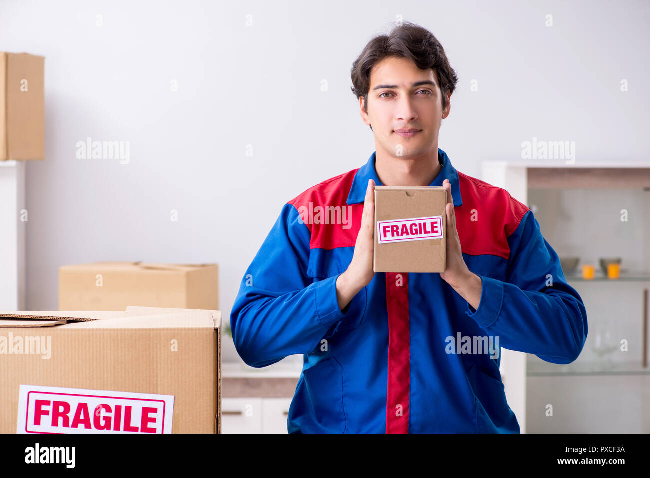 Transportation contractor with fragile boxes Stock Photo - Alamy