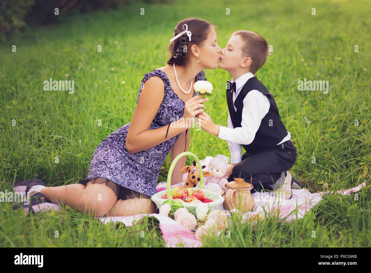 Little boy and teen age girl having picnic outdoors Stock Photo - Alamy