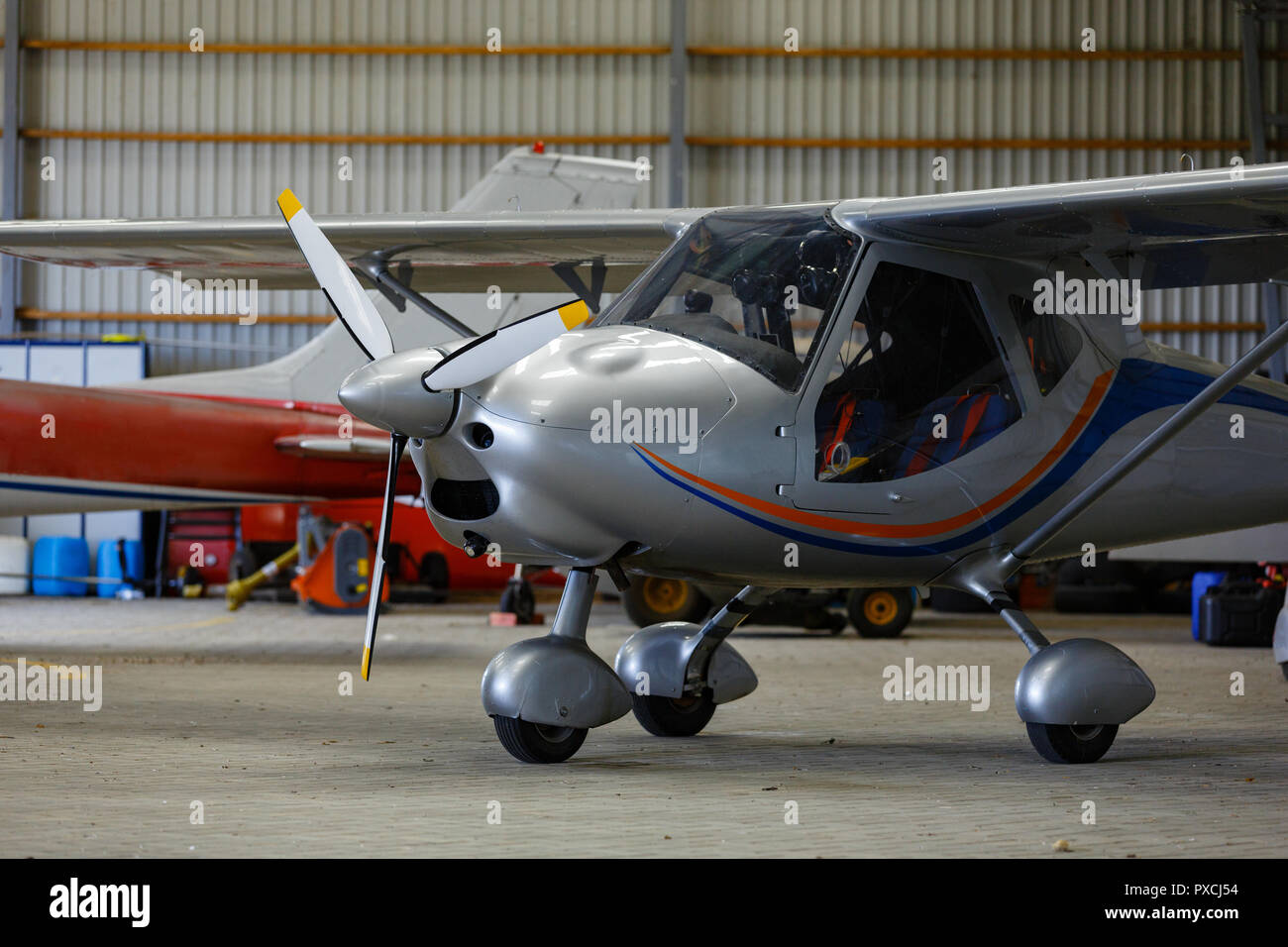 outdoor shot of small plane standing in shed Stock Photo - Alamy