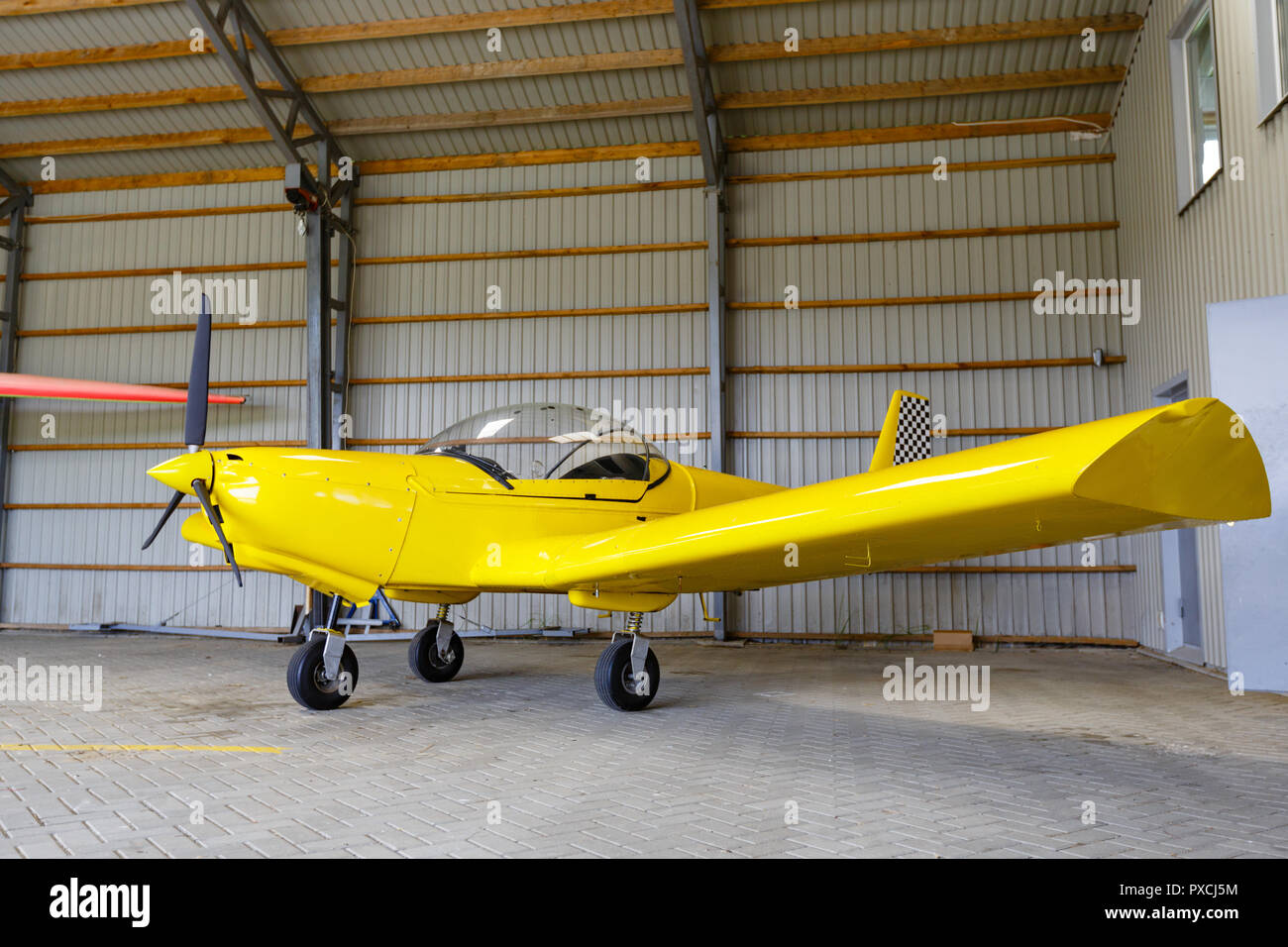 outdoor shot of small plane standing in shed Stock Photo - Alamy