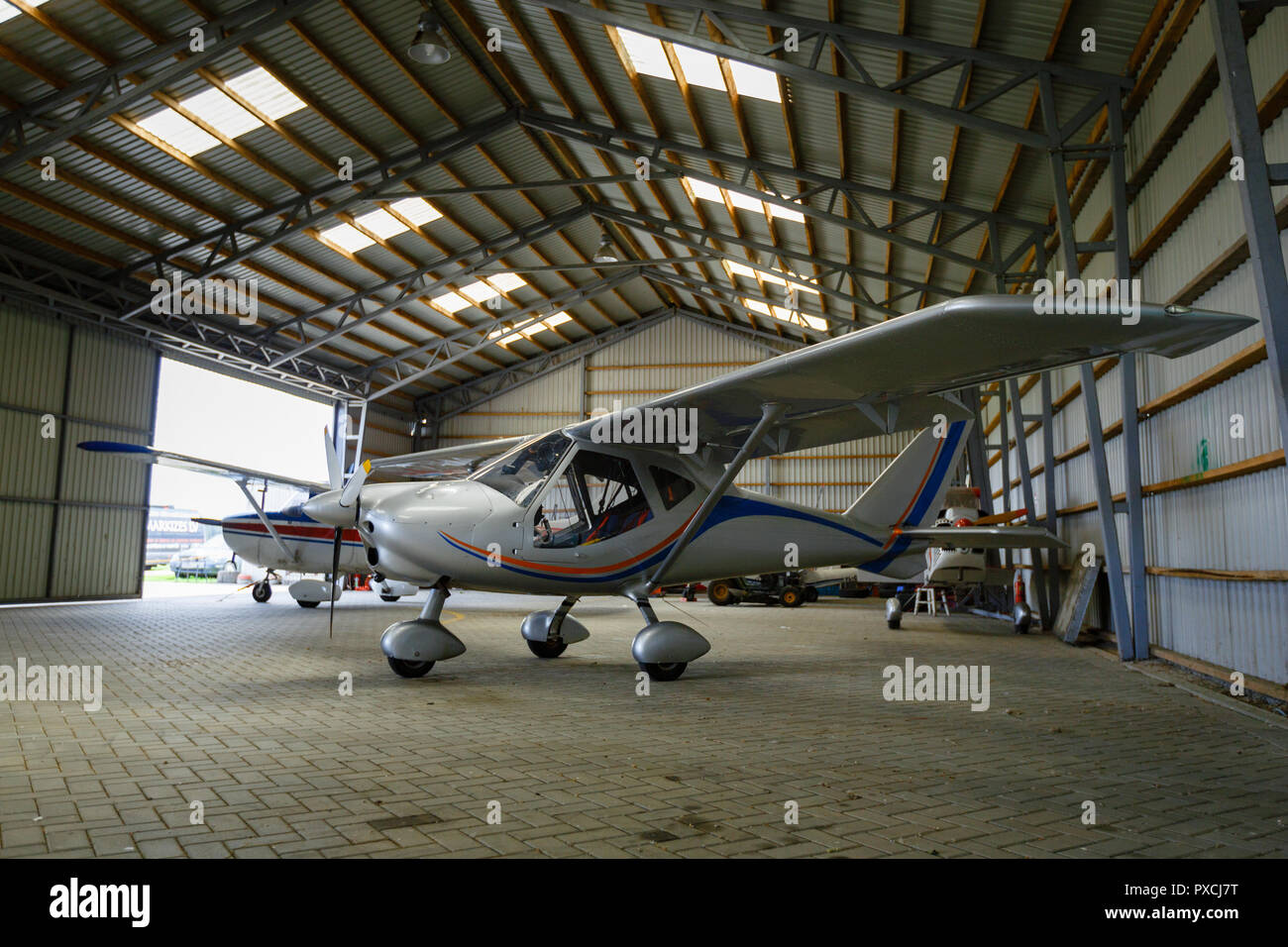 outdoor shot of small plane standing in shed Stock Photo - Alamy