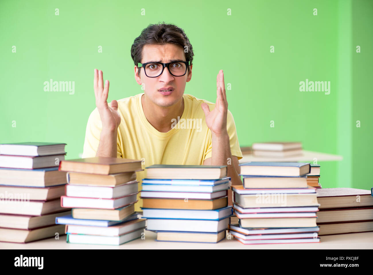 Student with too many books to read before exam Stock Photo - Alamy