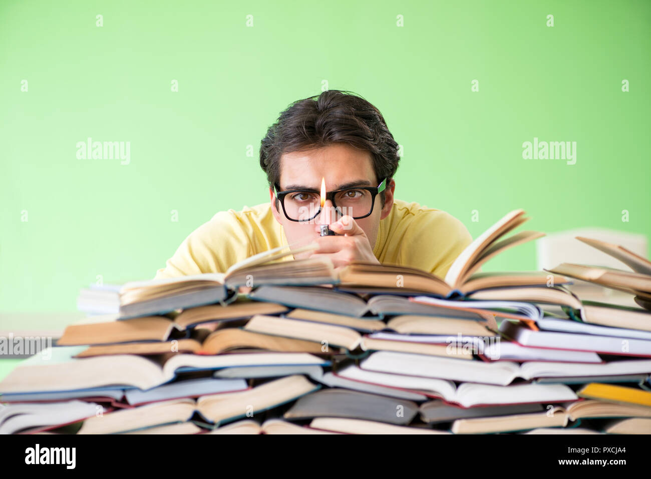 Student with too many books to read before exam Stock Photo - Alamy