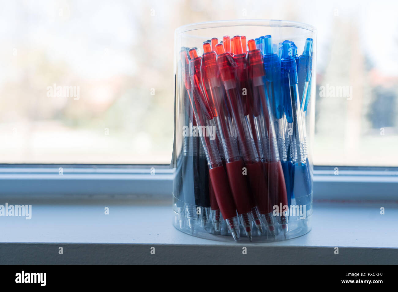 Collection of pens in office window at work Stock Photo - Alamy