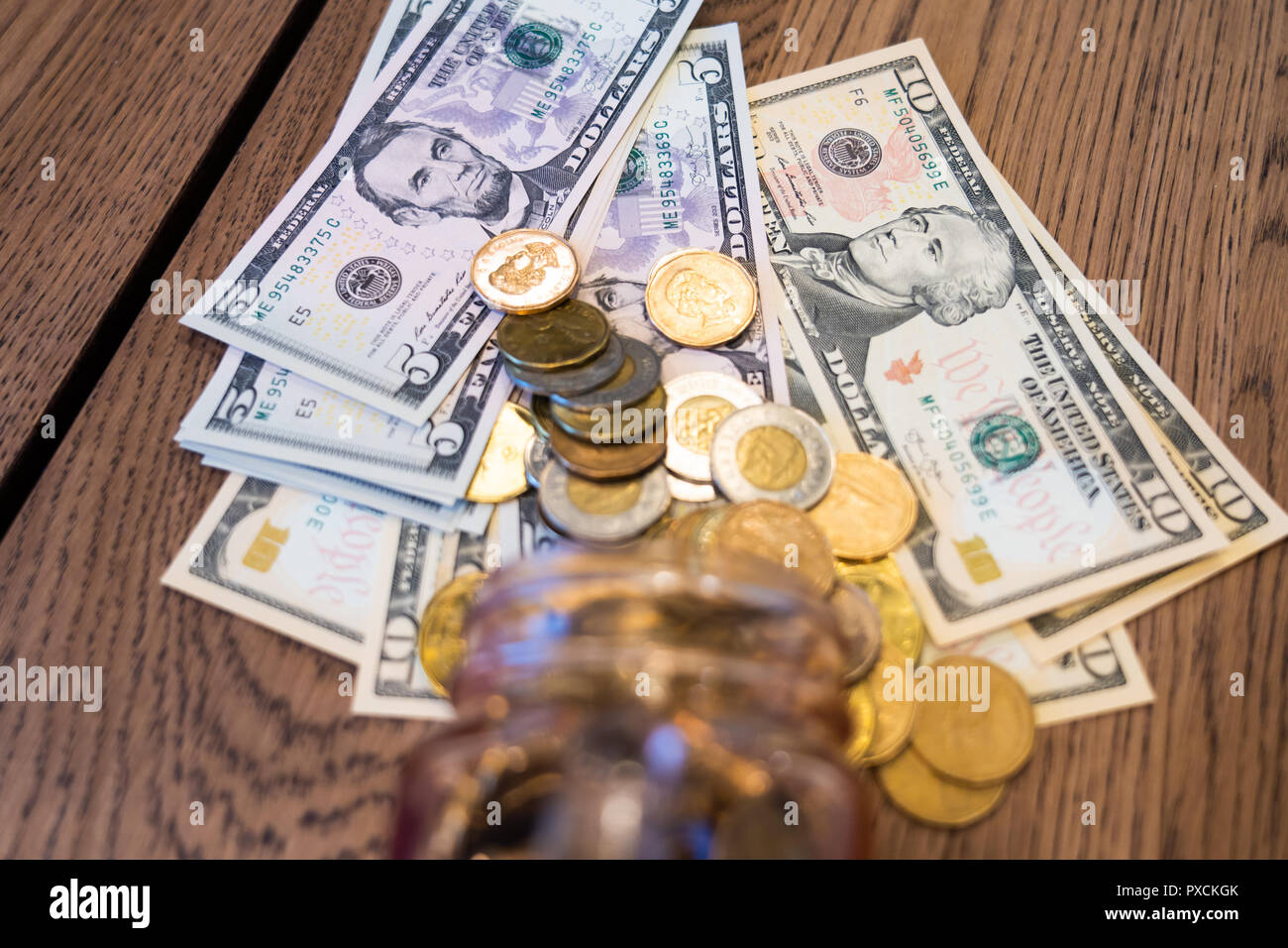 Bank notes with coins shwing spending money Stock Photo - Alamy