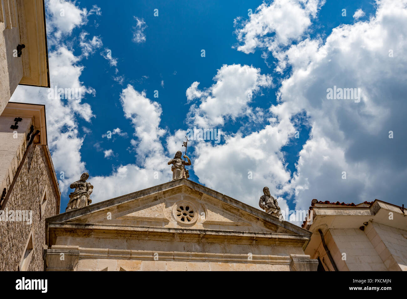 Travel photo with religious architecture, street view of three statues ...