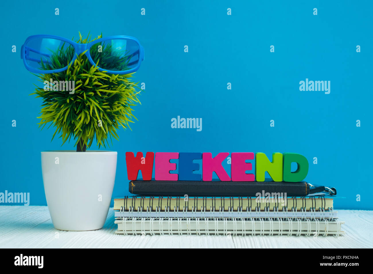 WEEKEND letters text and notebook paper and little decoration tree in ...