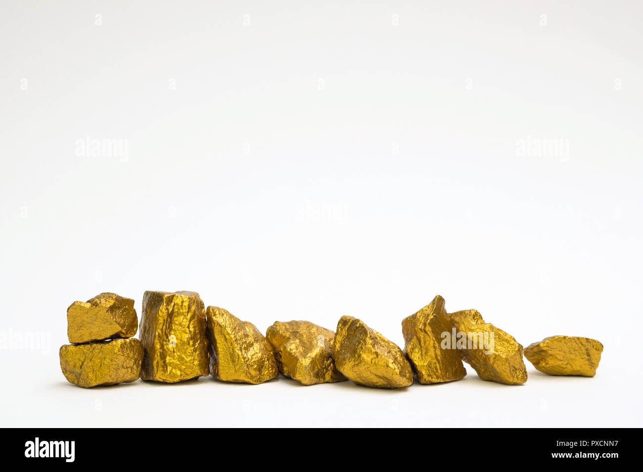 A pile of gold nuggets or gold ore on white background, precious stone ...