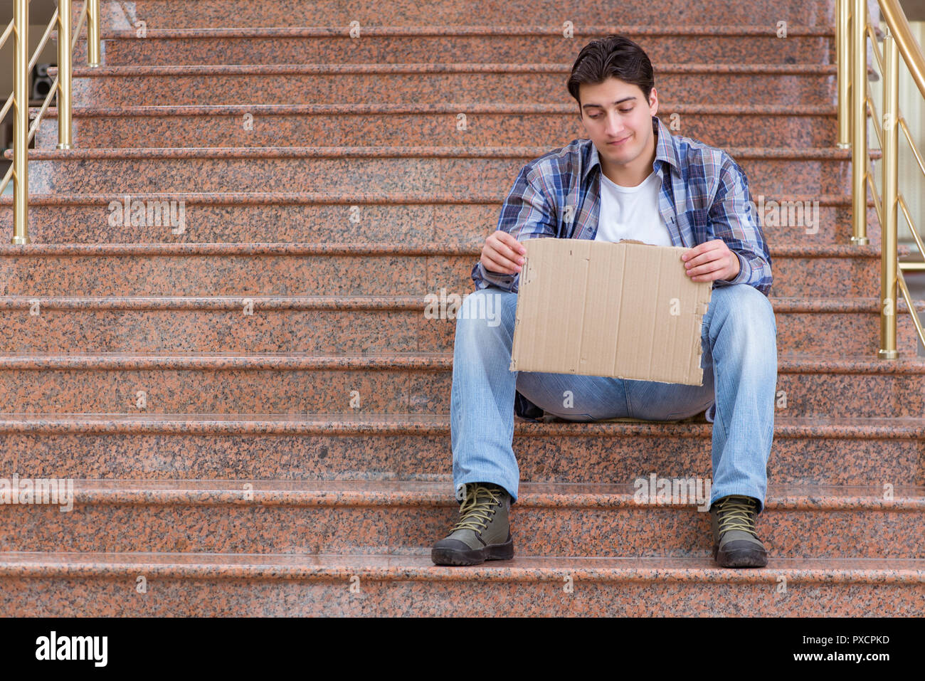 Young man begging money on the street Stock Photo - Alamy