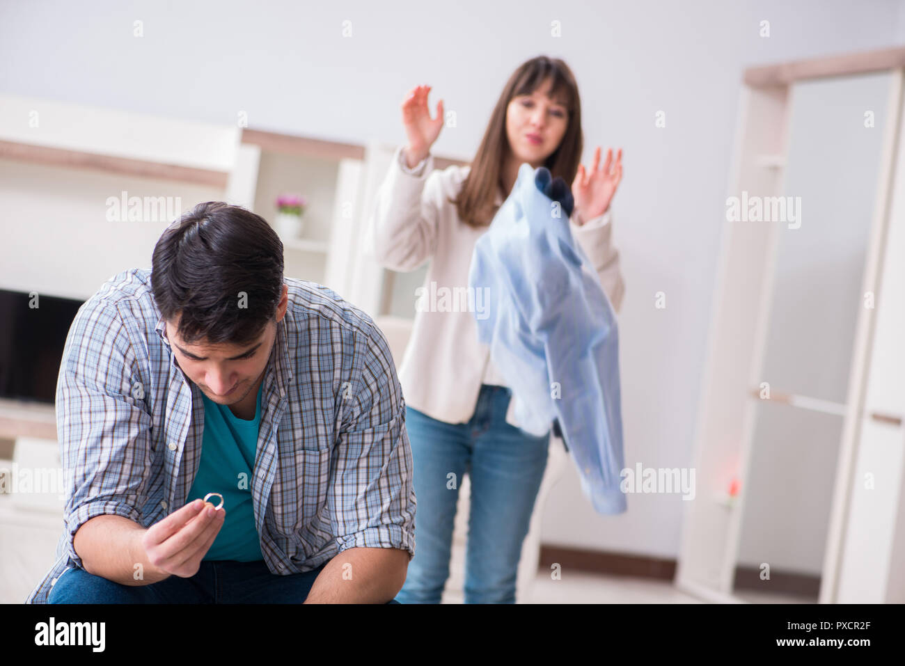 Woman evicting man from house during family conflict Stock Photo - Alamy