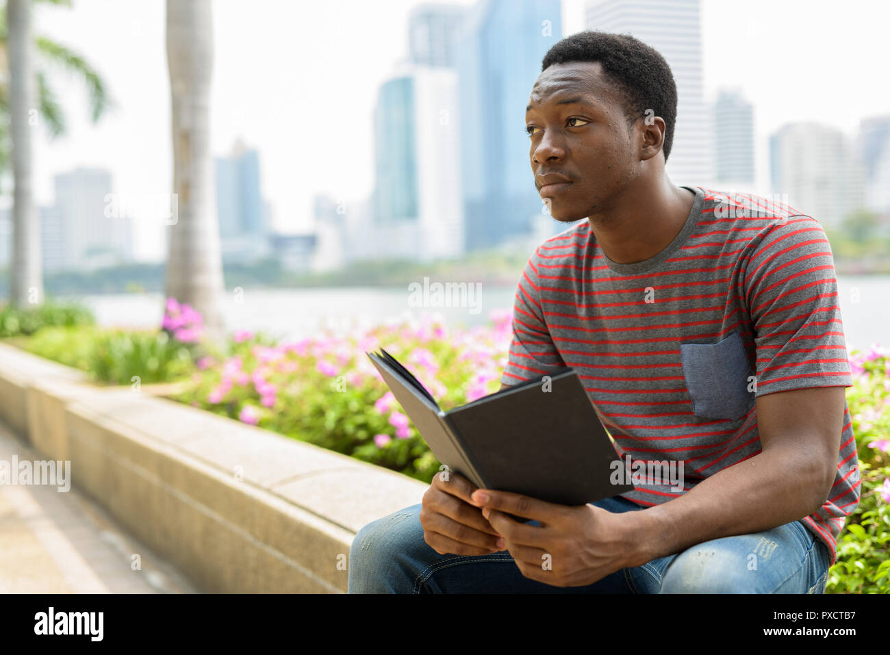 African man sitting reading book hi-res stock photography and images ...