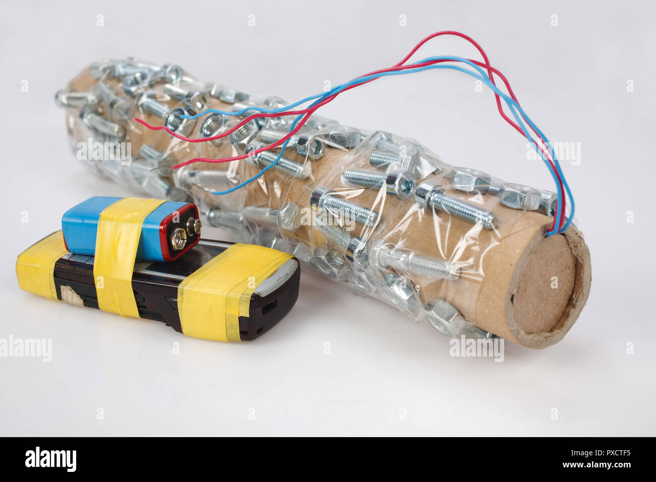 Handmade pipe bomb with cell phone firing device on white background ...