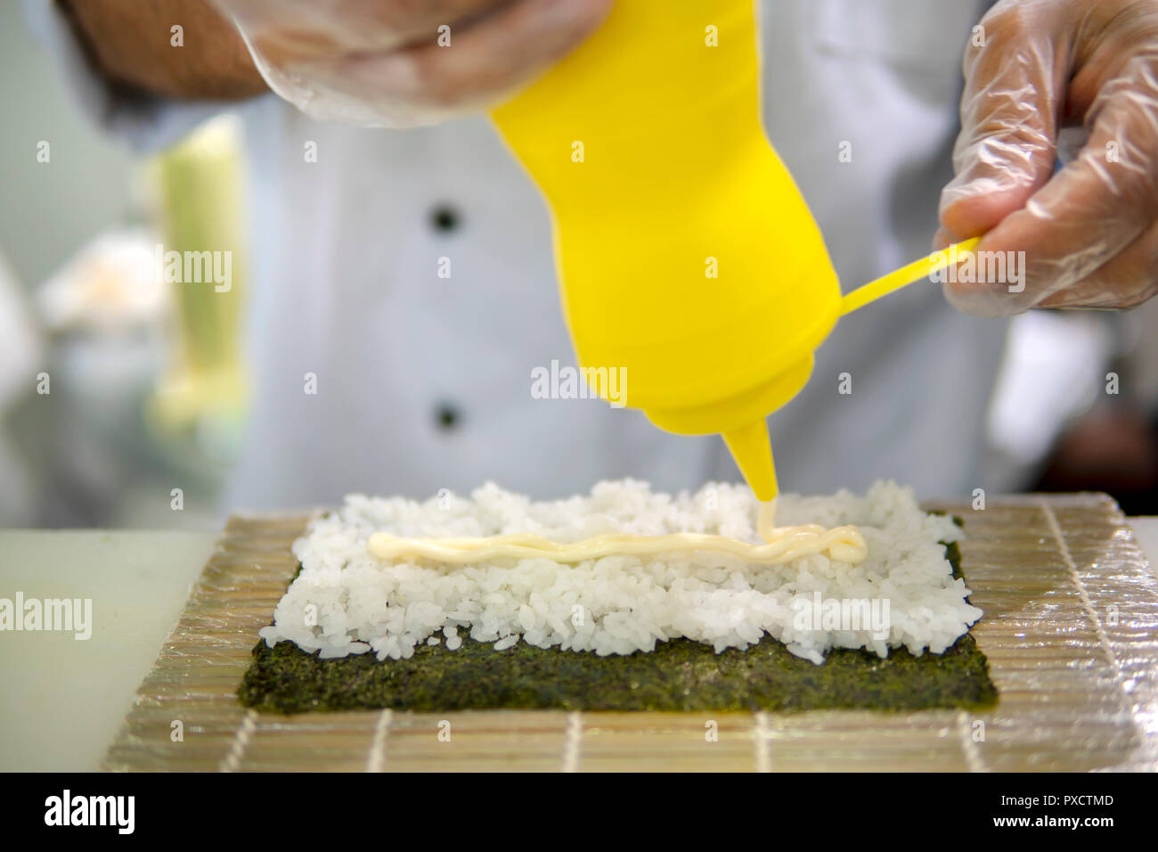 The process of making sushi in the restaurant. In the frame - the hands ...