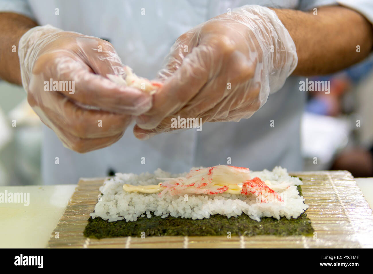 The process of making sushi in the restaurant. In the frame - the hands ...
