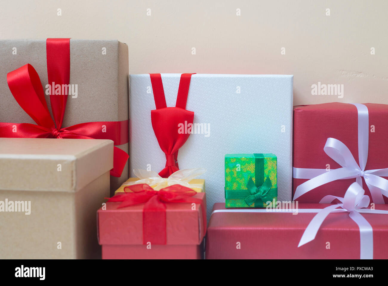 Many color gift boxes with ribbon isolated on white background, to send ...