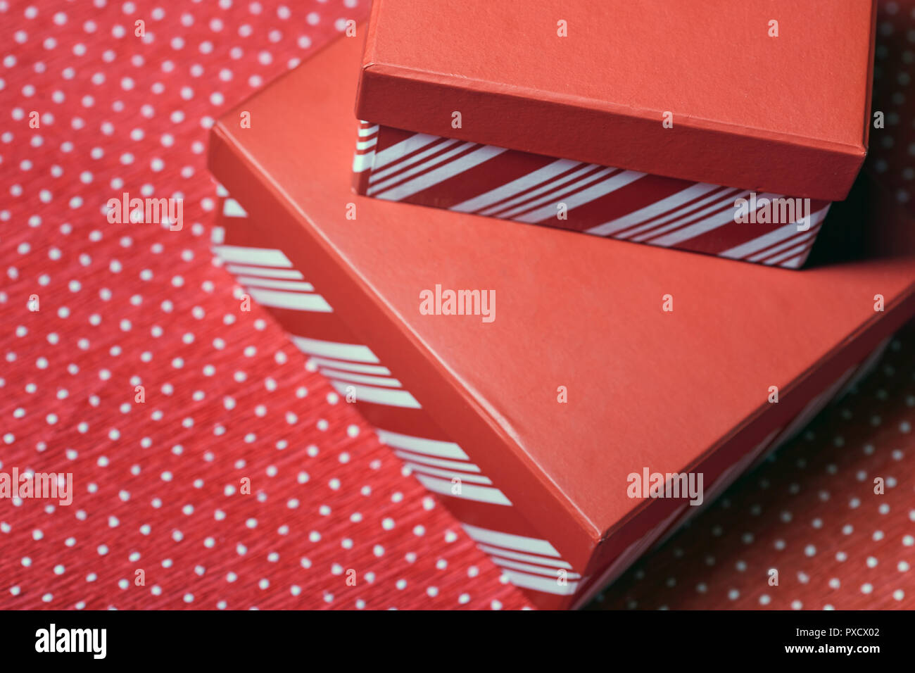 Christmas gift boxes on a red wrapping paper Stock Photo - Alamy