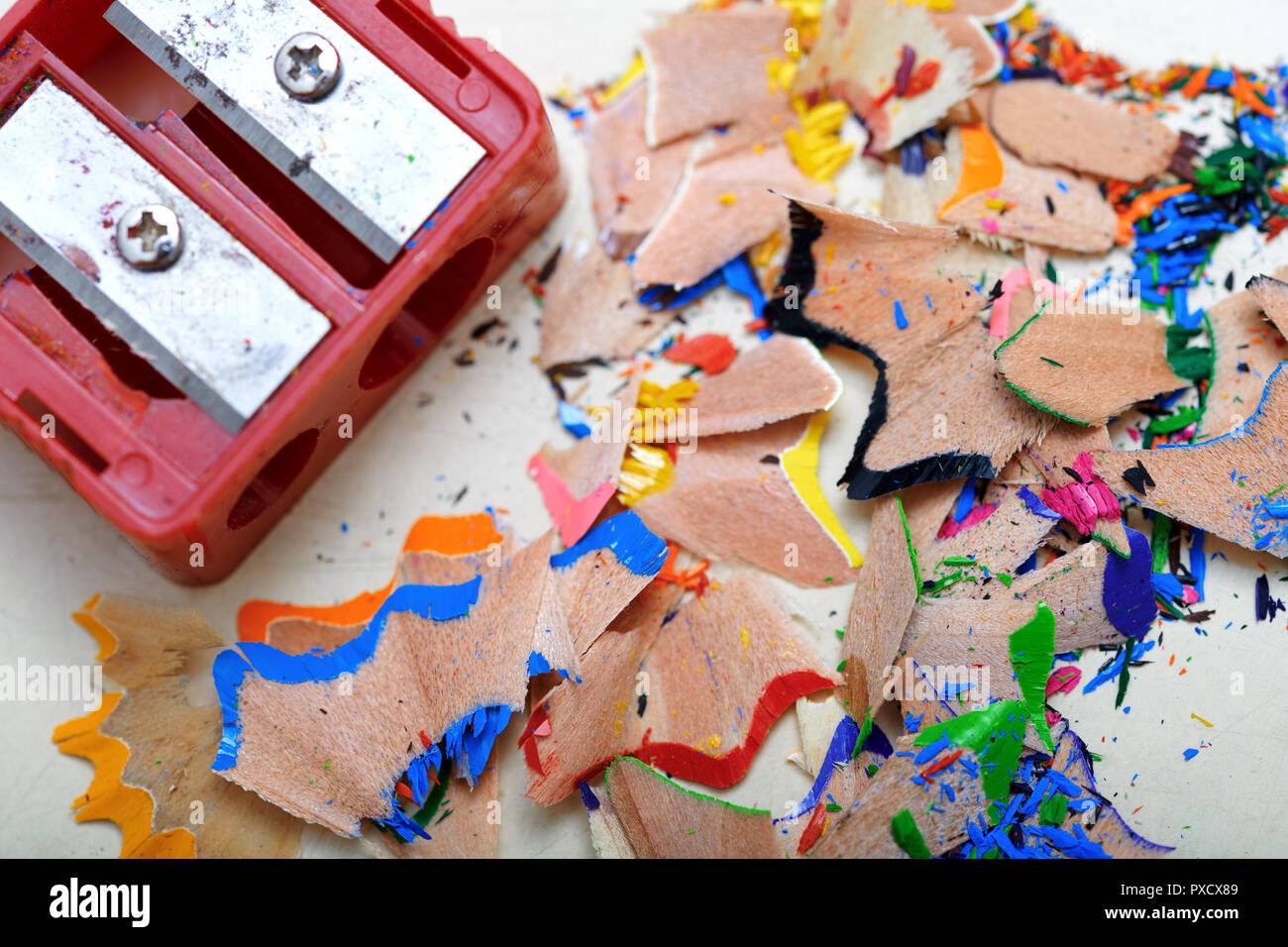 Sharpener and colored pencil shavings Stock Photo - Alamy