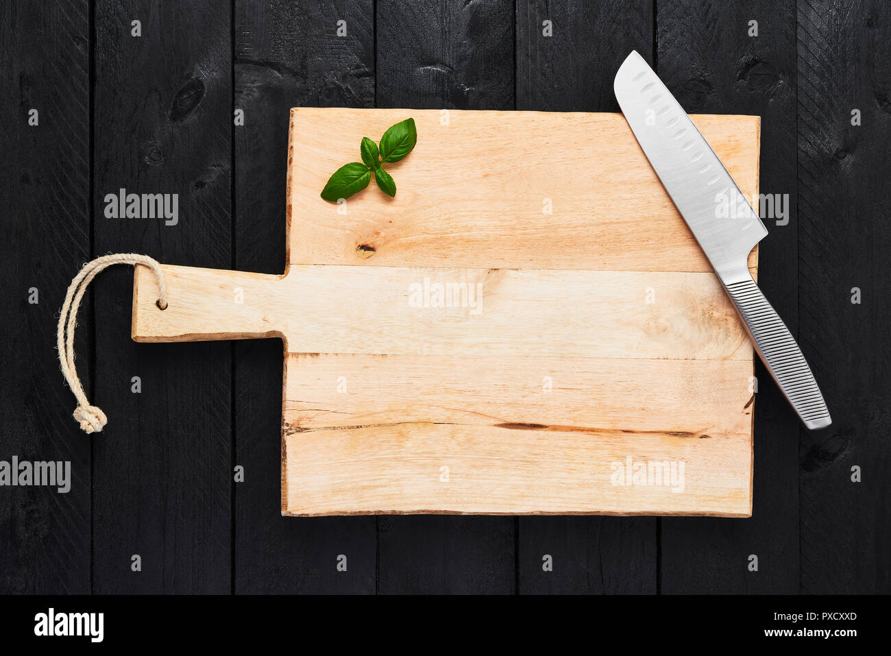 Top view of chopping board with stainless steel vegetable knife and ...