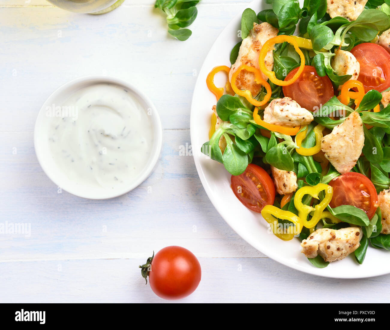 Vegetable salad with chicken meat on white wooden background. Top view ...
