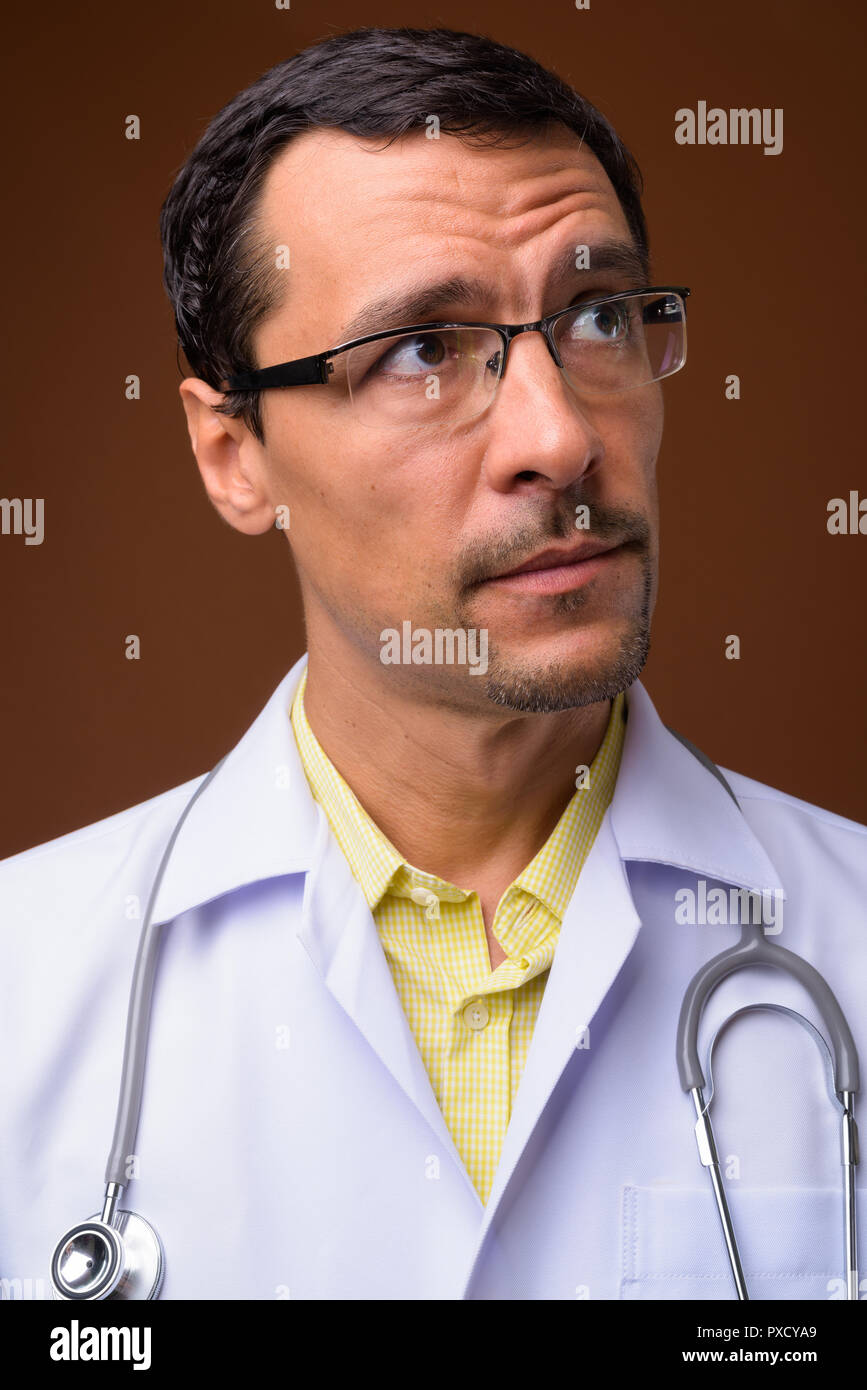 Portrait of handsome man doctor thinking face Stock Photo - Alamy