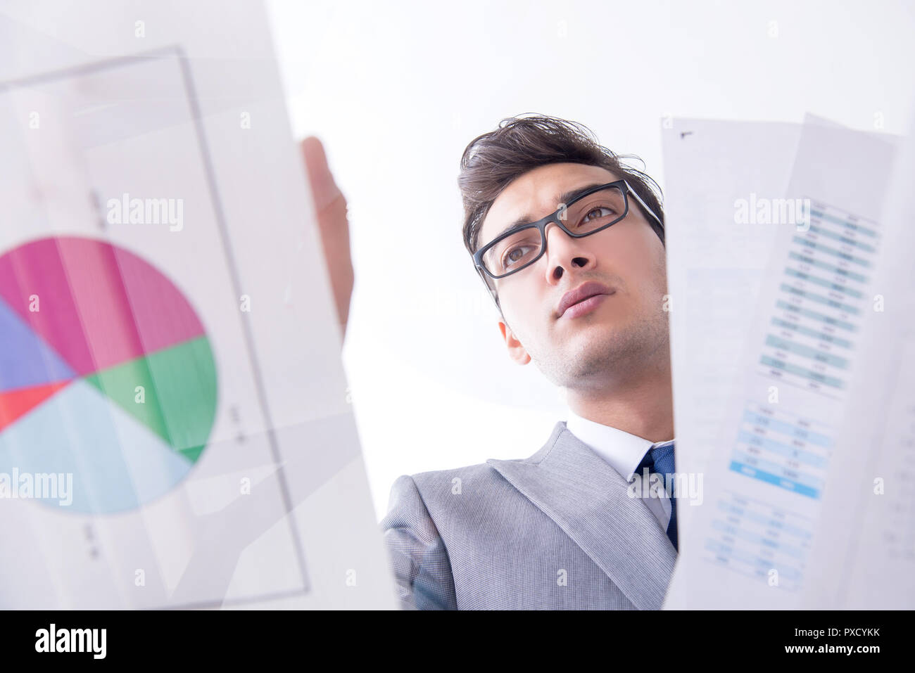 Businessman looking at financial charts and graphs Stock Photo - Alamy