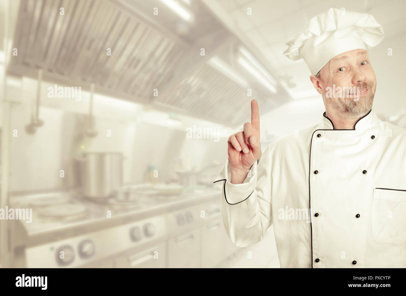 Portrait of a cheerful male chef cook. Background - the kitchen Stock ...